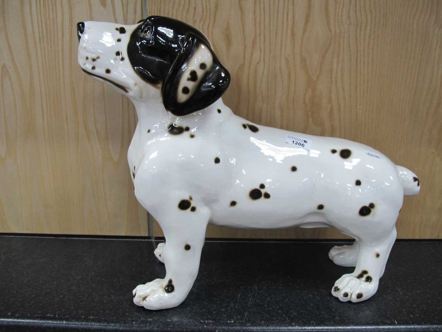 Lot 1206 - A large ceramic black and white spotted dog