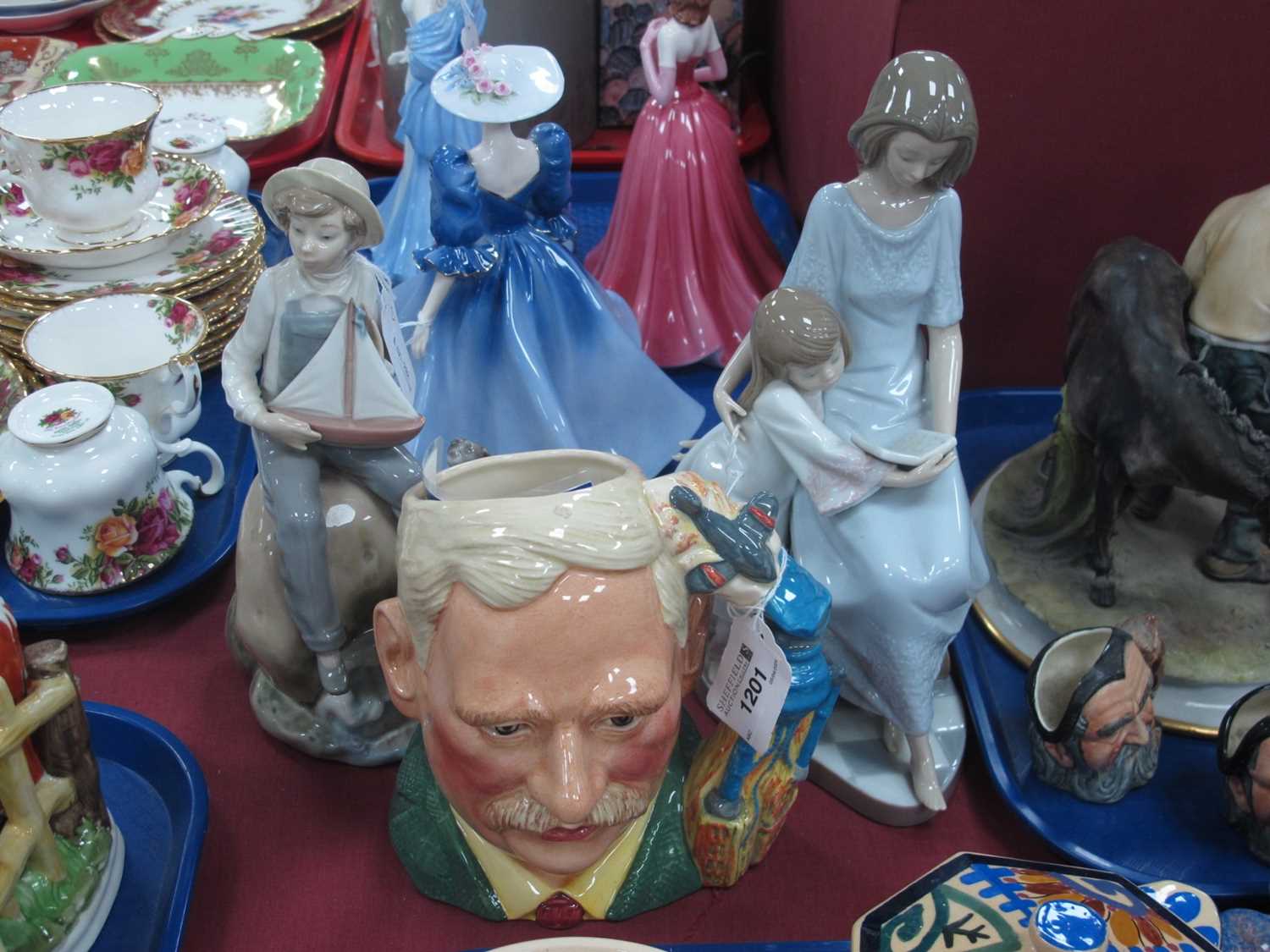 Lot 1201 - Lladro Figurines, of a boy, sat on rocks,