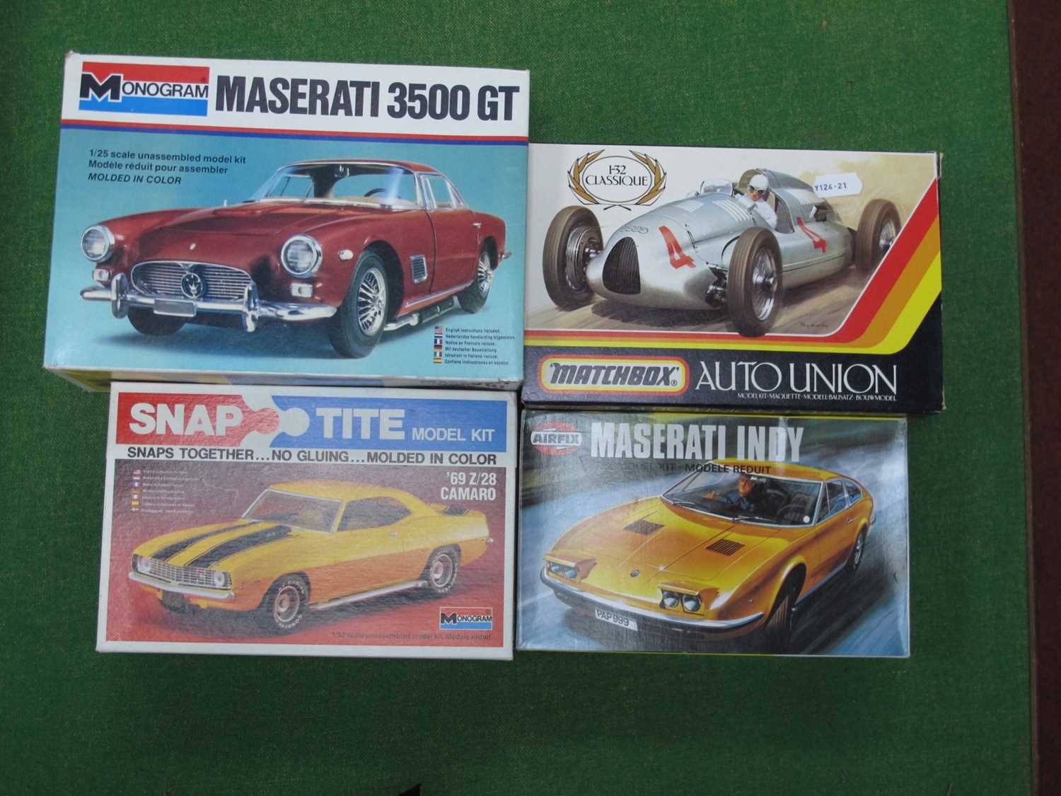 Lot 703 - Four plastic model car kits comprising of