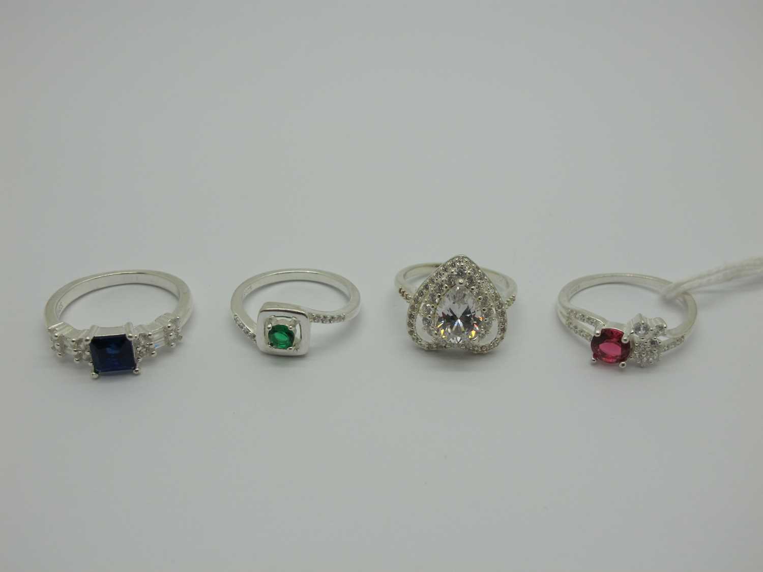 Lot 249 - Four Modern Dress Rings, claw set, stamped