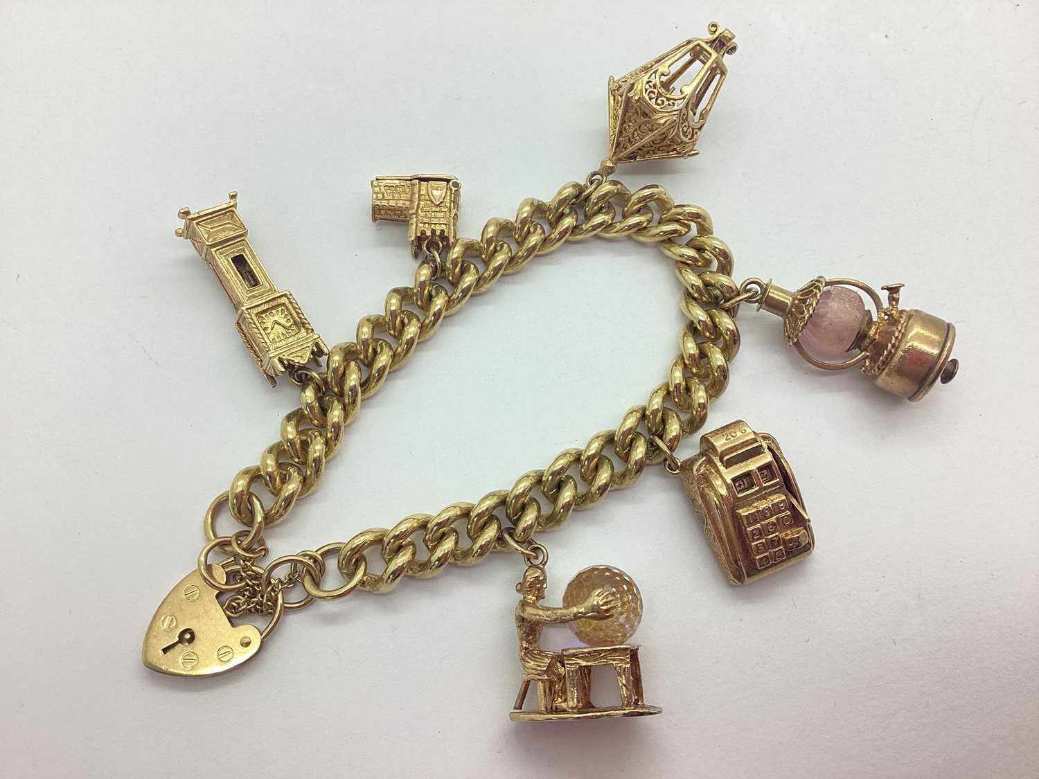 Lot 64 - A 9ct Solid Gold Curb Link Charm Bracelet, to