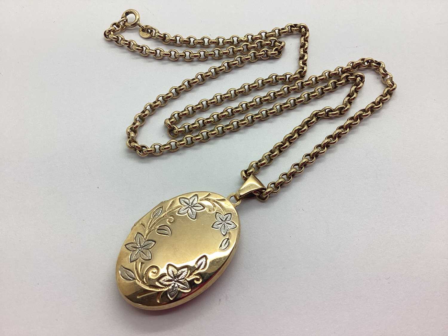 Lot 82 - A Modern 9ct Gold Oval Locket Pendant, two