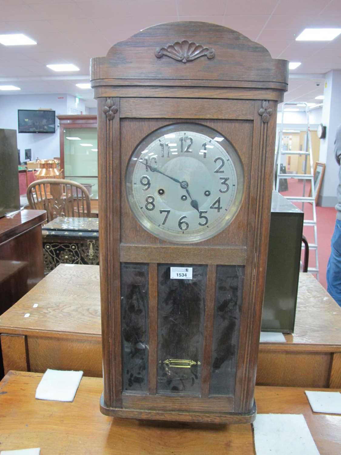 Lot 1534 - A 1940s oak cased wall clock with a